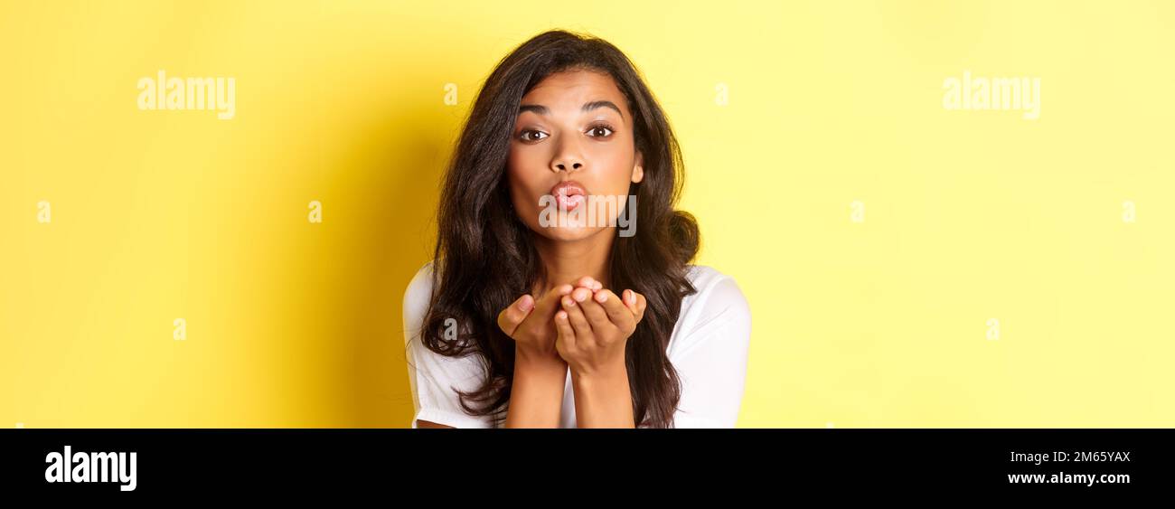 Close-up of beautiful and romantic african-american woman, pucker lips ...