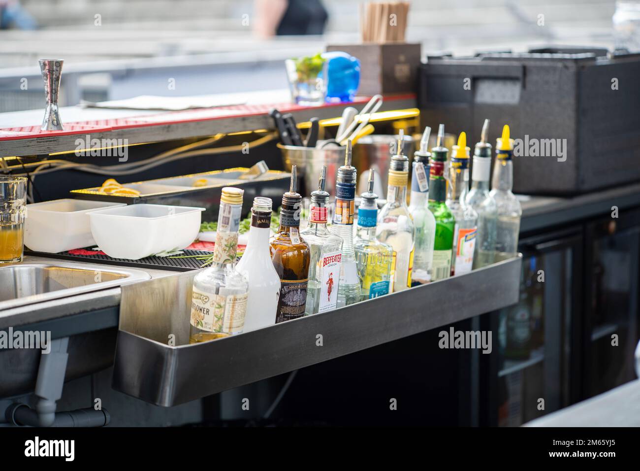 A set of alcohol bottles behind the bar, different liquor bottles ...