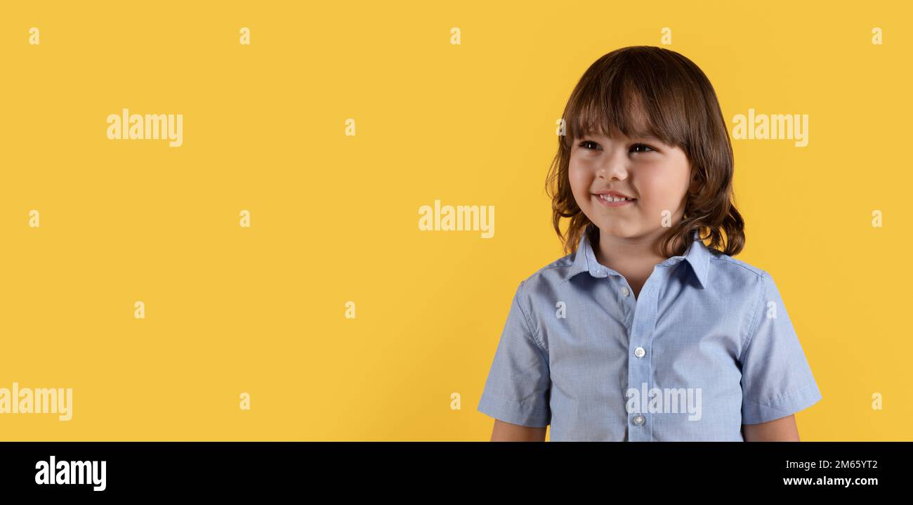 Kids development products. Adorable happy little boy looking aside at ...