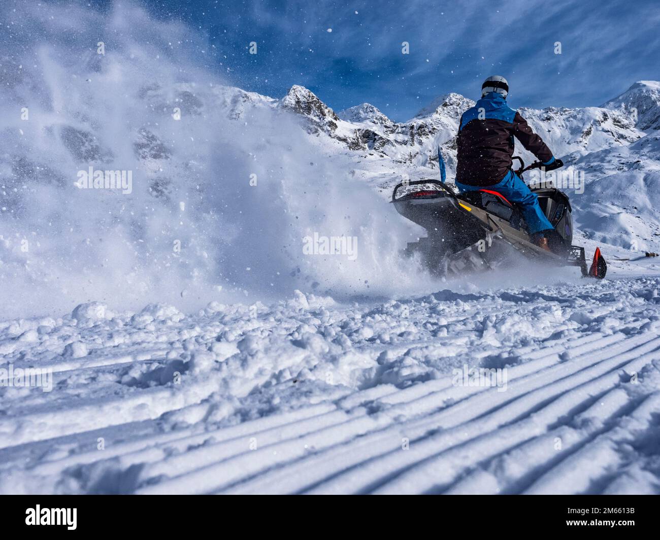 Snowmobile on a trail in the Italian alps Stock Photo - Alamy