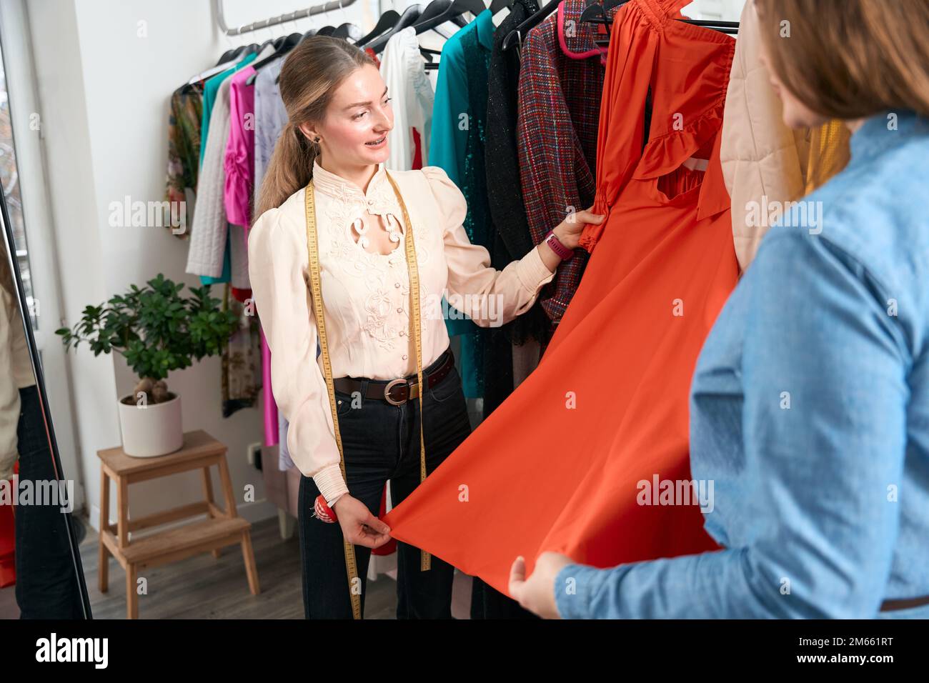 Dressmaker measuring female client hi-res stock photography and images ...