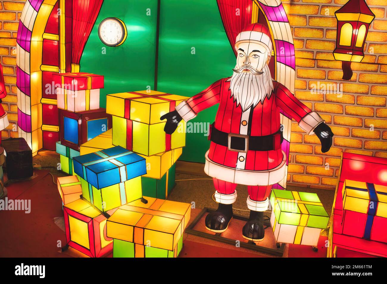 An illuminated Father Christmas figure at Santa's workshop display with ...