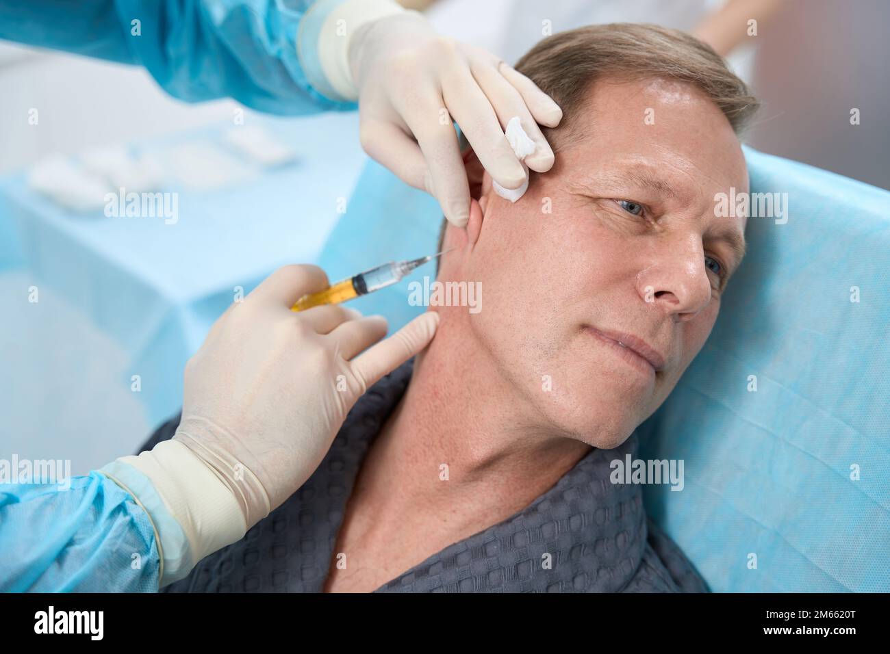 Adult man looking pleased during medical injection Stock Photo - Alamy