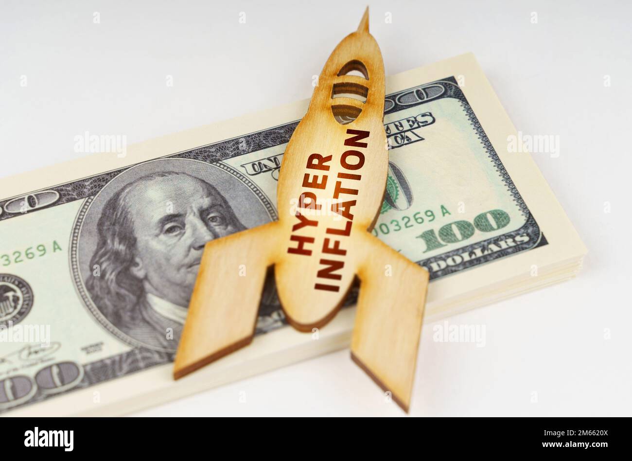 Business concept. On the dollars lies a wooden model of a rocket with ...