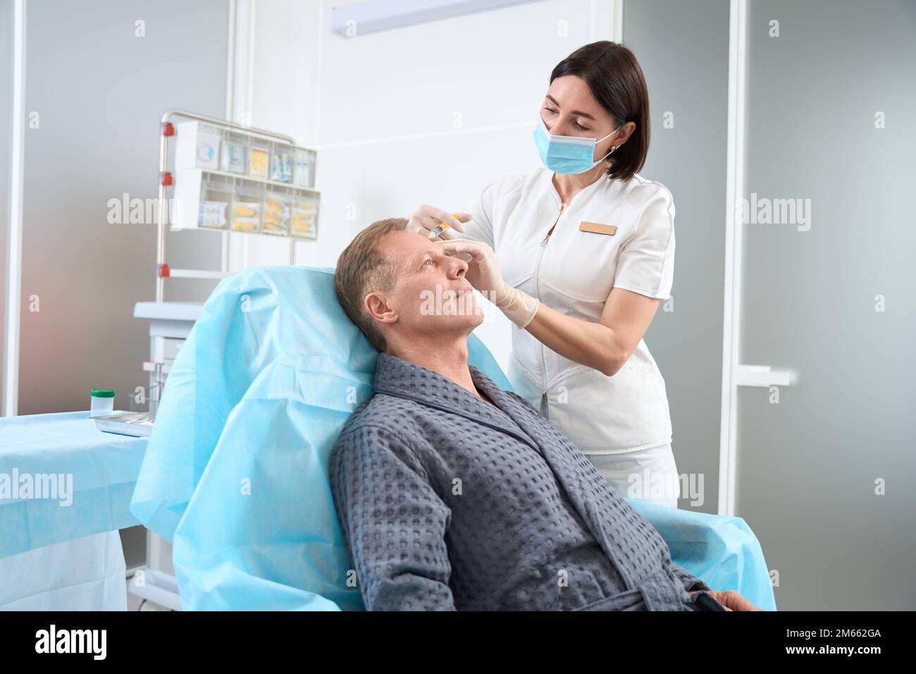 Male doctor using syringe hi-res stock photography and images - Alamy
