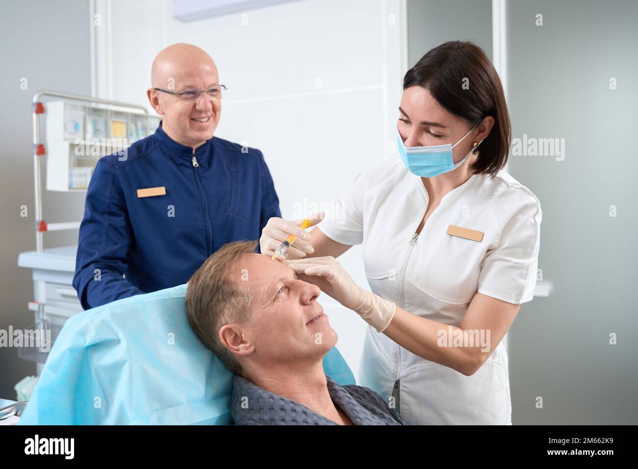 Mature man receiving facial plasma injection at modern clinic Stock ...