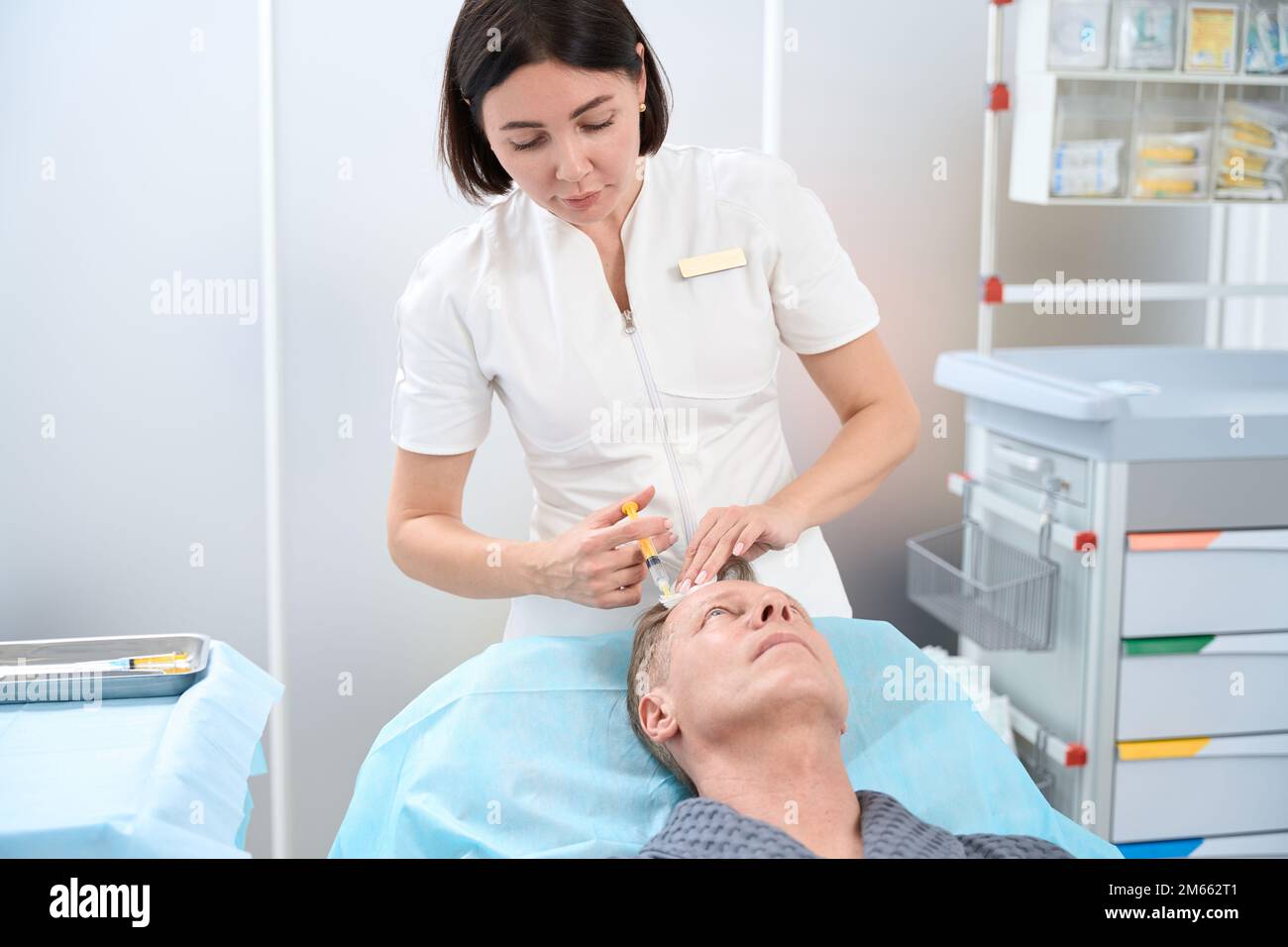 Professional cosmetologist doing skin regeneration procedure for a man ...