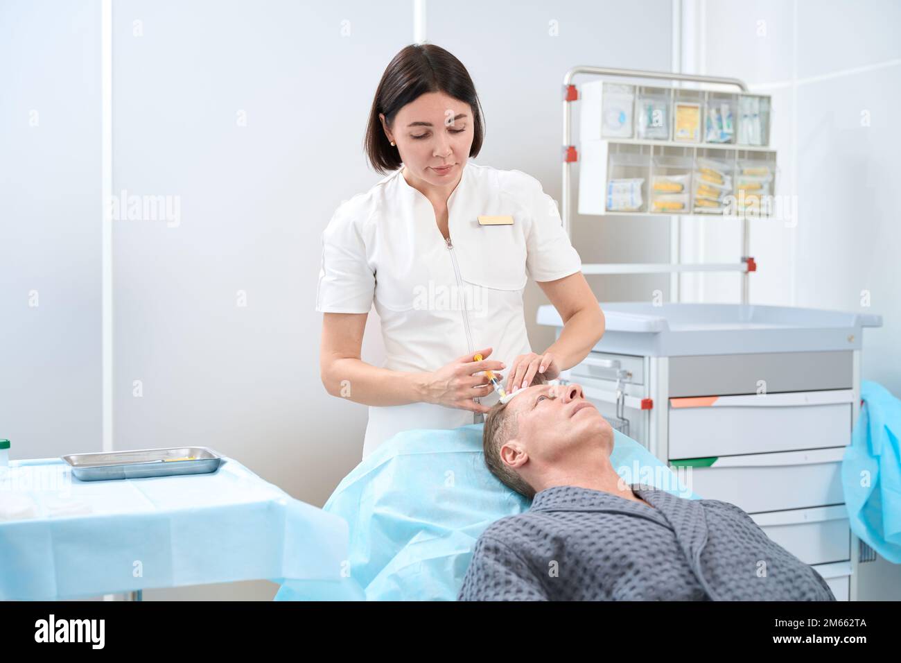 Professional medic delivering a skin regeneration injection for aging ...