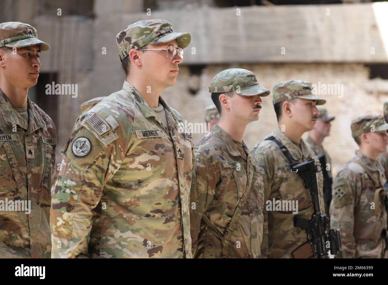 U.S. Soldiers assigned to Task Force Pioneer stand at the position of ...