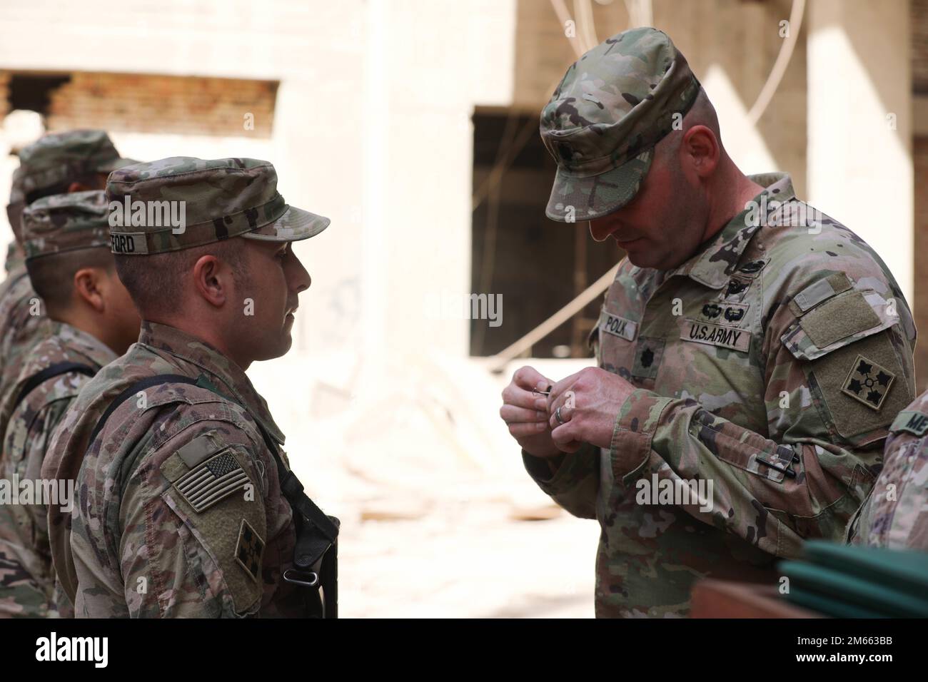 Lt. Col. Gregory Polk, commander, Task Force Pioneer, prepares to clip ...
