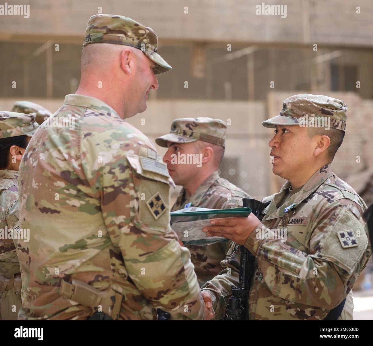 Lt. Col. Gregory Polk, the 299th Engineer Battalion commander, hands a ...