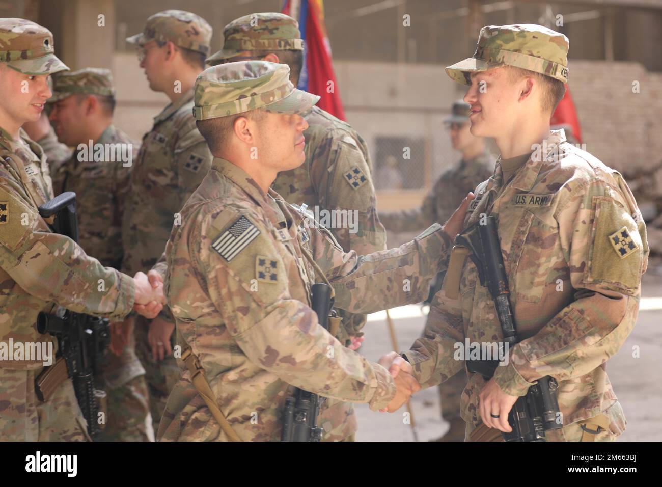 U.S. Soldiers assigned to Task Force Pioneer congratulate their peers ...