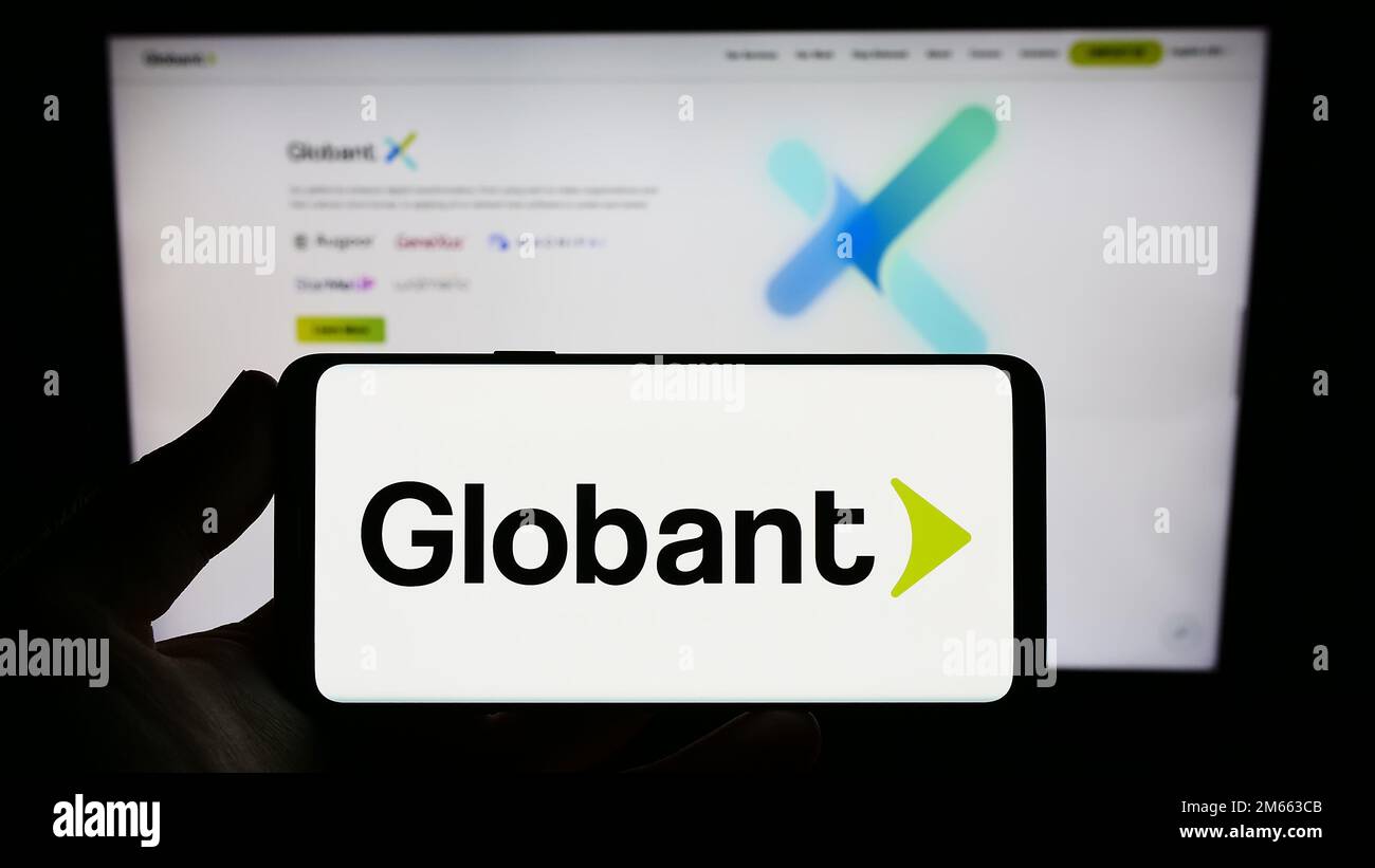 Person holding smartphone with logo of software company Globant S.A. on ...