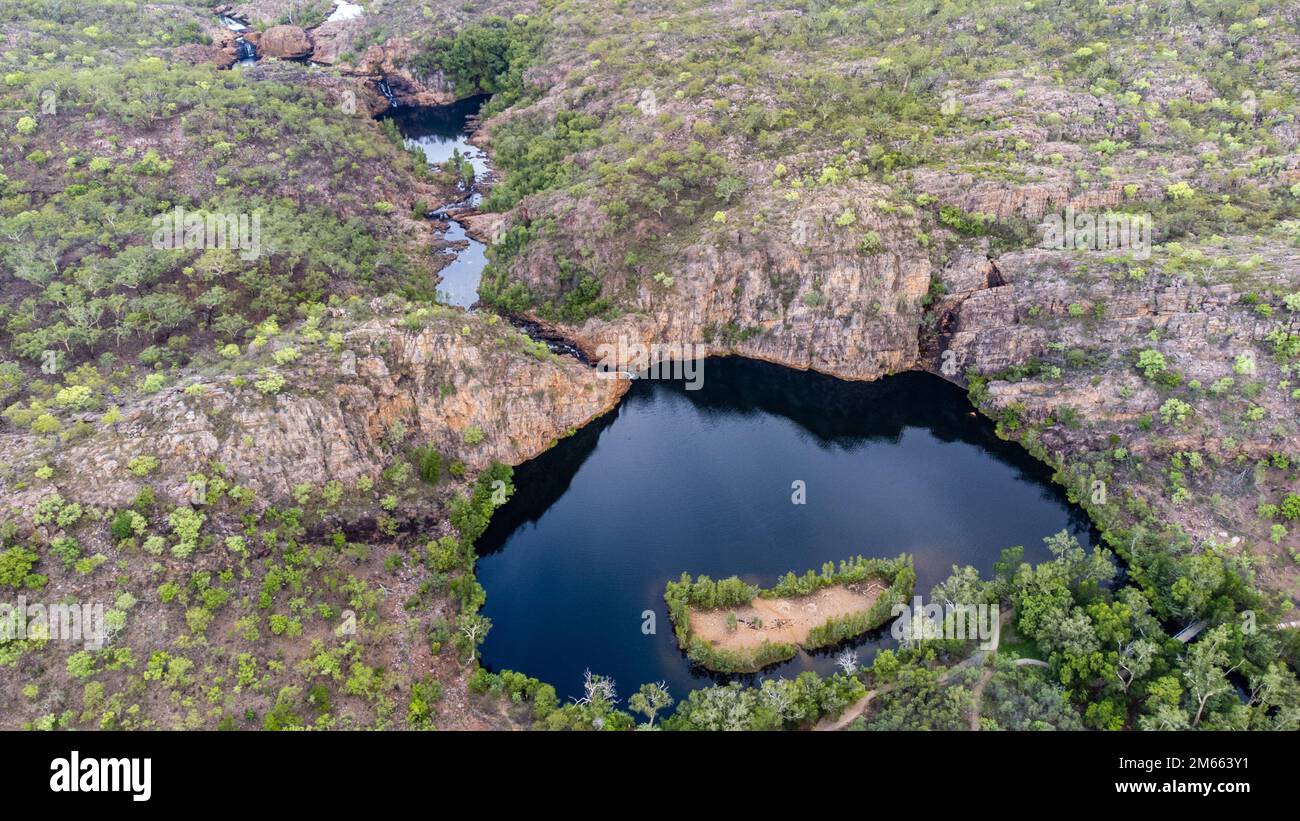 An aerial view of a lake surrounded by cliffs covered in trees Stock ...