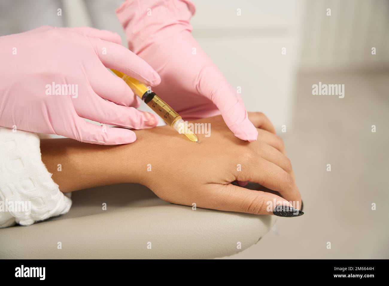 Medical worker doing injections for African American woman Stock Photo ...