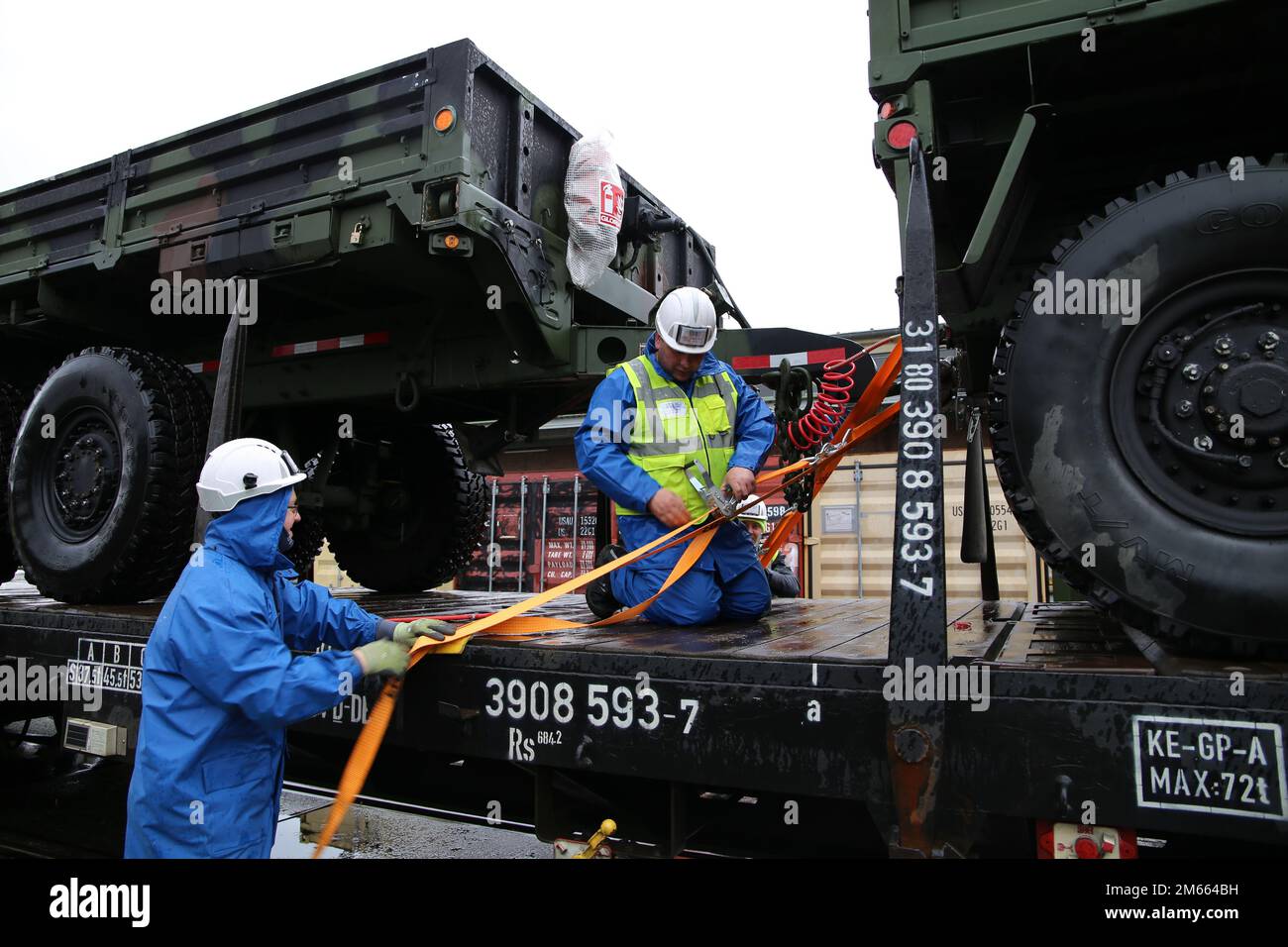 Contractors help load rail cars shipping out materiel in preparation ...