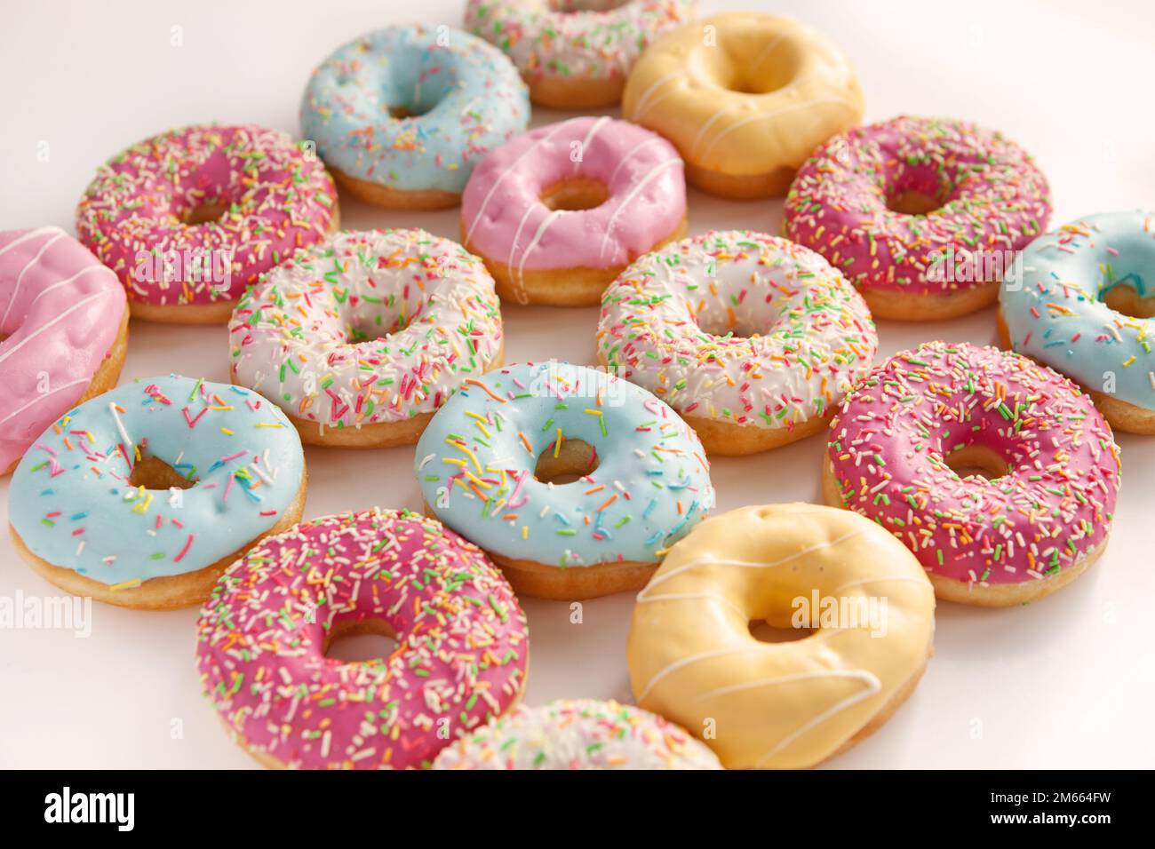 Colorful delicious donuts isolated on white background Stock Photo - Alamy
