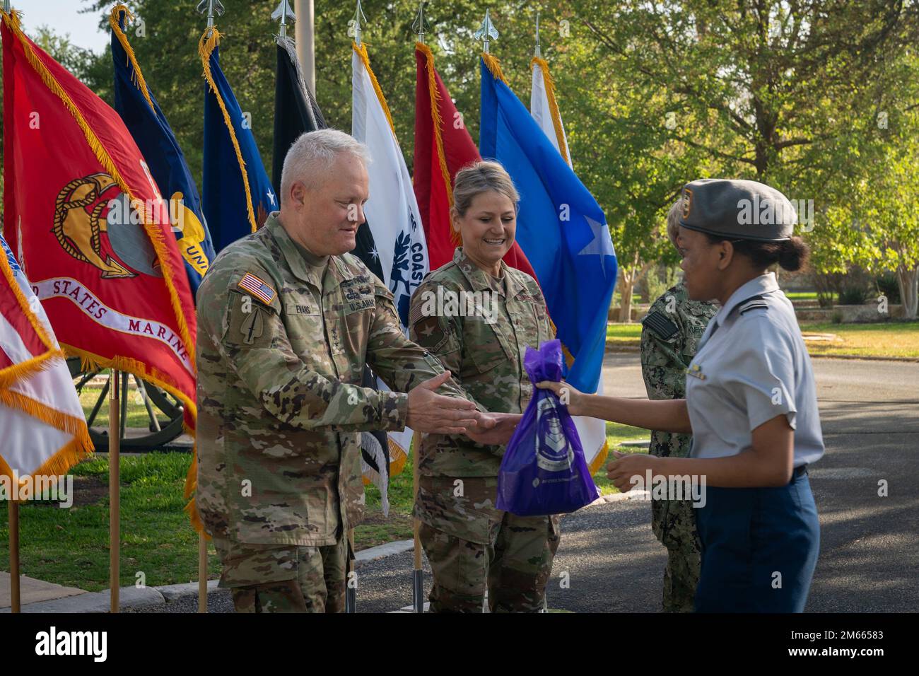 U.S. Army Lt. Gen. John R. Evans, Army North commanding general, receives a gift from one of the ...