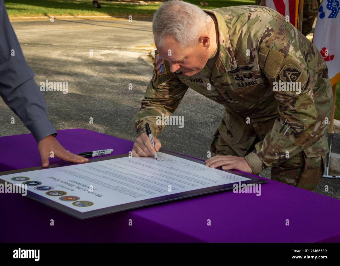 U.S. Army Lt. Gen. John R. Evans, Army North commanding general, signs ...