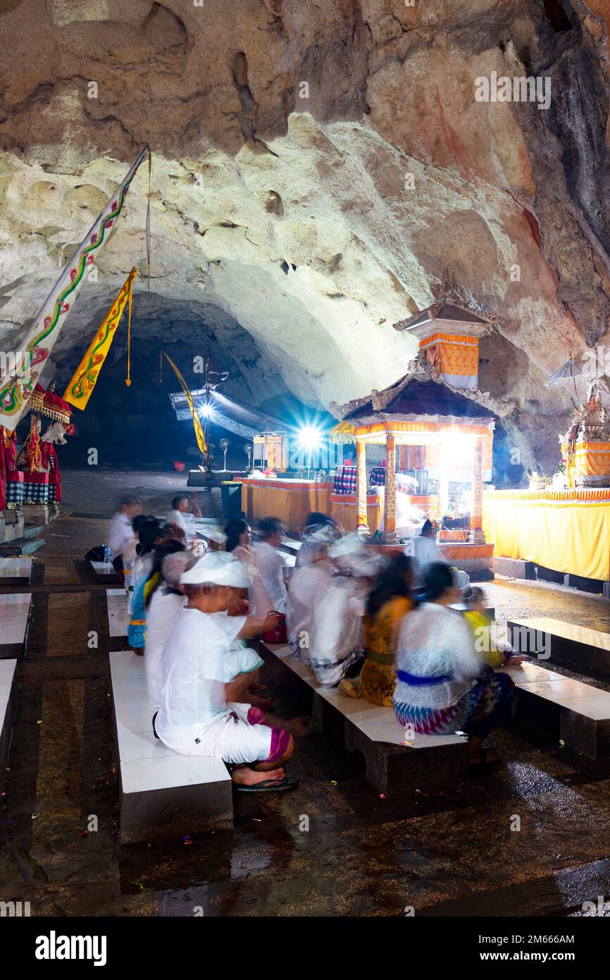 People pray inside Goa Giri Putri temple Stock Photo - Alamy