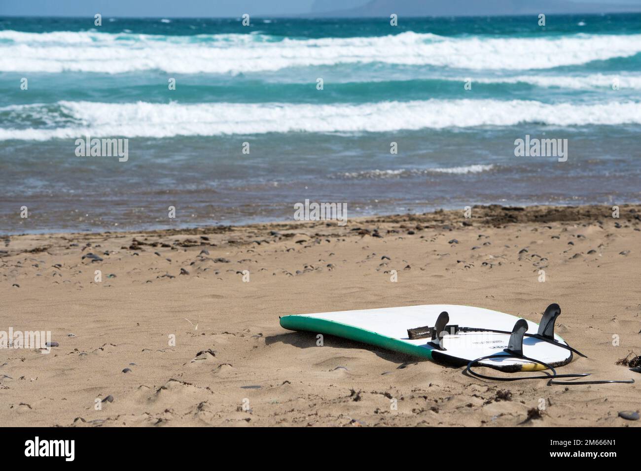 Surfboard At Beach facing the sea. Golden beach and waves in the ...