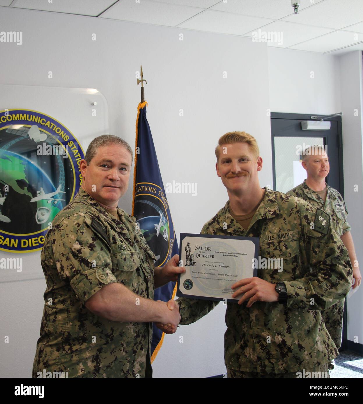 CDR Nichols presents IT2 Johnson with Junior Sailor of the Quarter ...