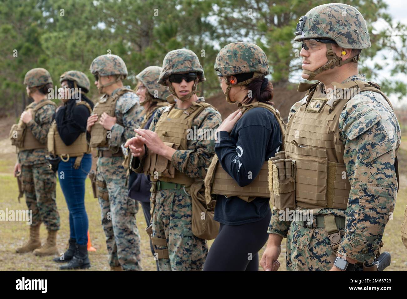 U.S. Marine Corps combat marksmanship coaches wait with military family ...