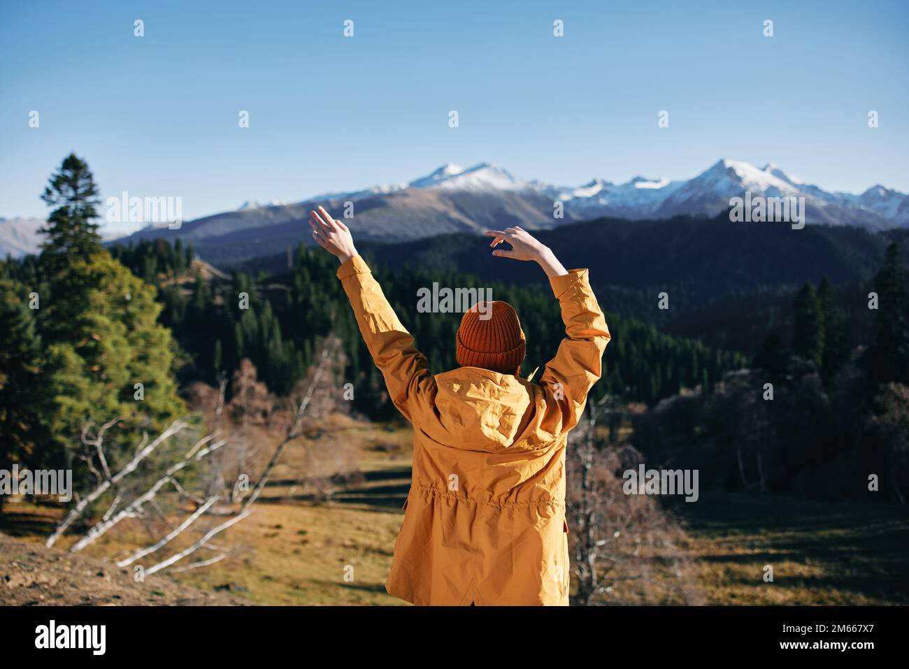 Woman full-length hiker standing with her back raised hands up on the ...