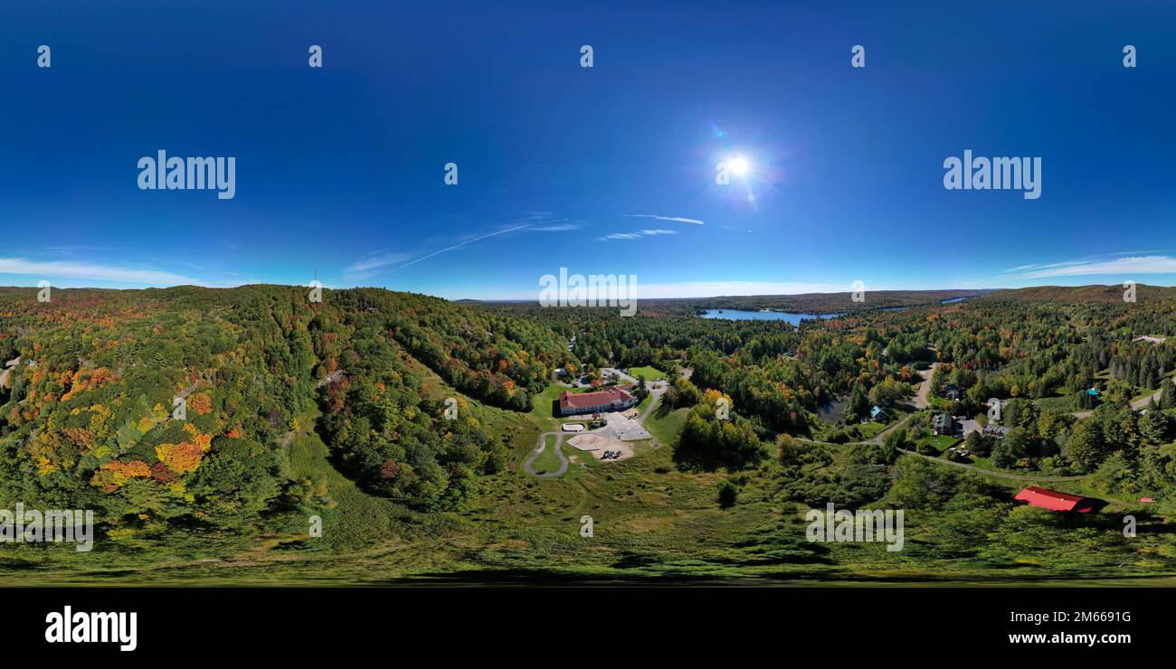 A panoramic of a resort surrounded by a picturesque nature with dense ...