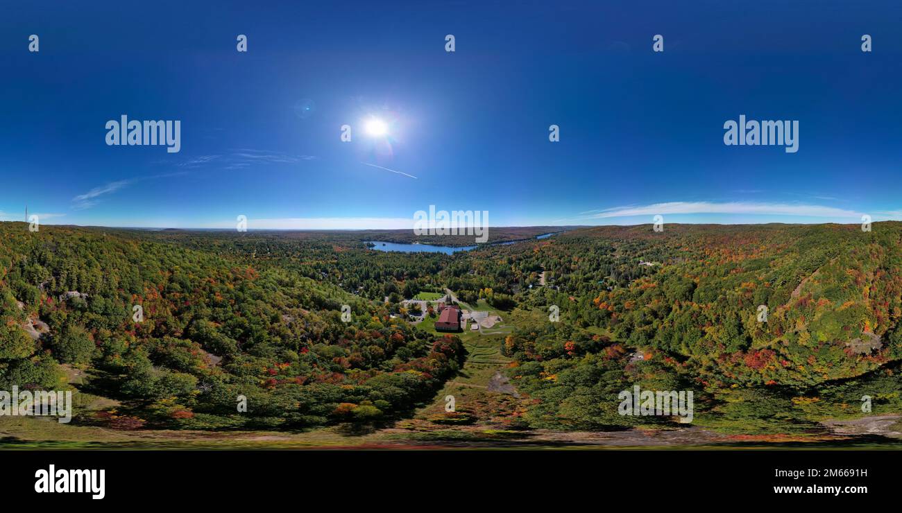 A panoramic of a resort surrounded by a picturesque nature with dense ...