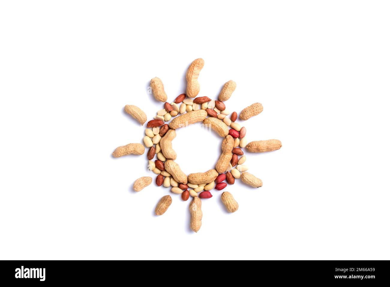 Flat lay peanuts laid out in the shape of the sun, unshelled and ...