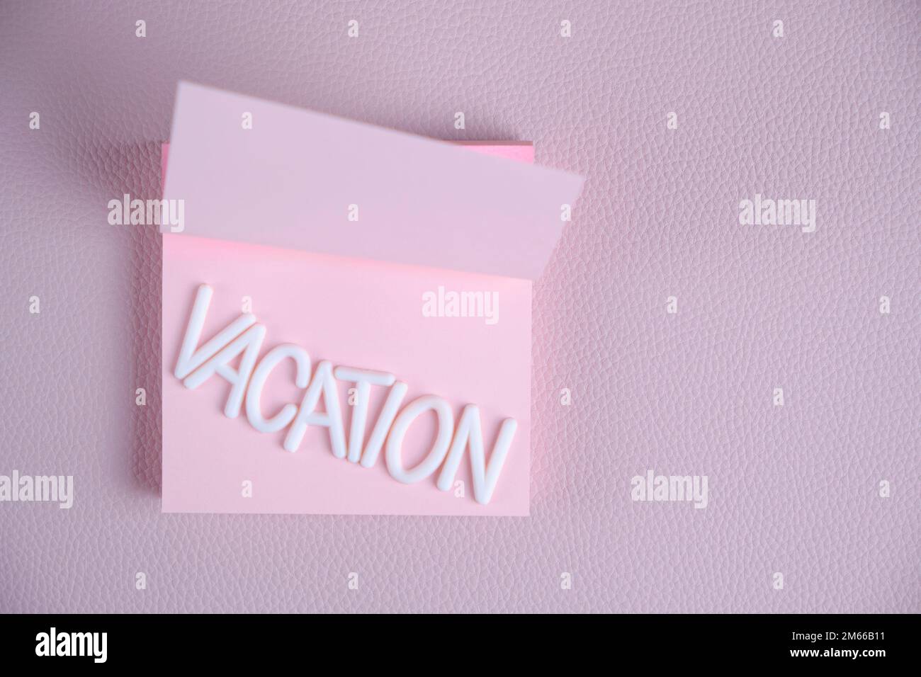 Word vacation laid out white letters pink piece paper.Concept vacation ...