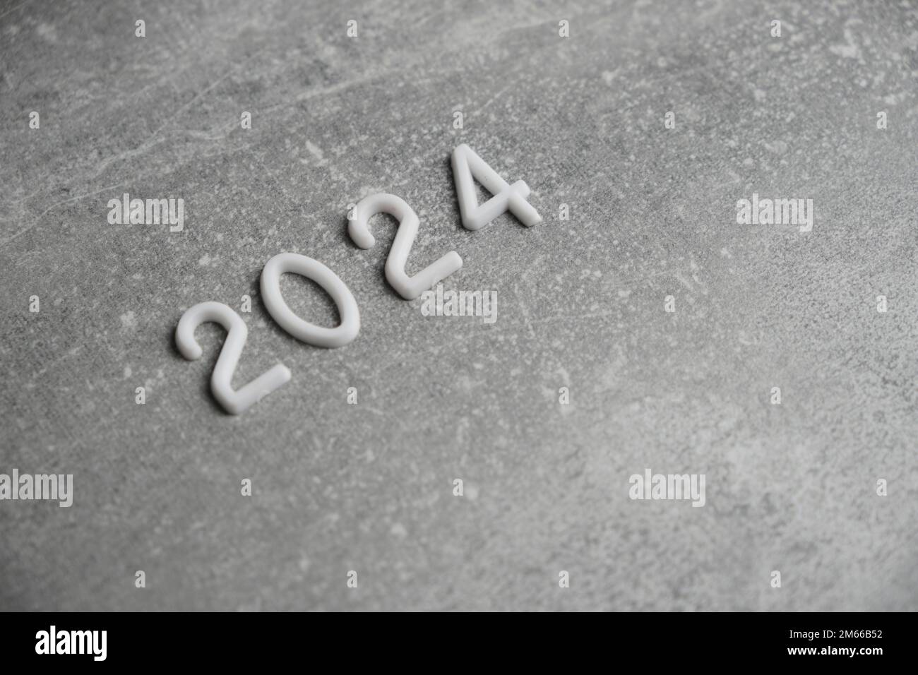 Year 2024 laid out in white numbers gray concrete background Stock ...
