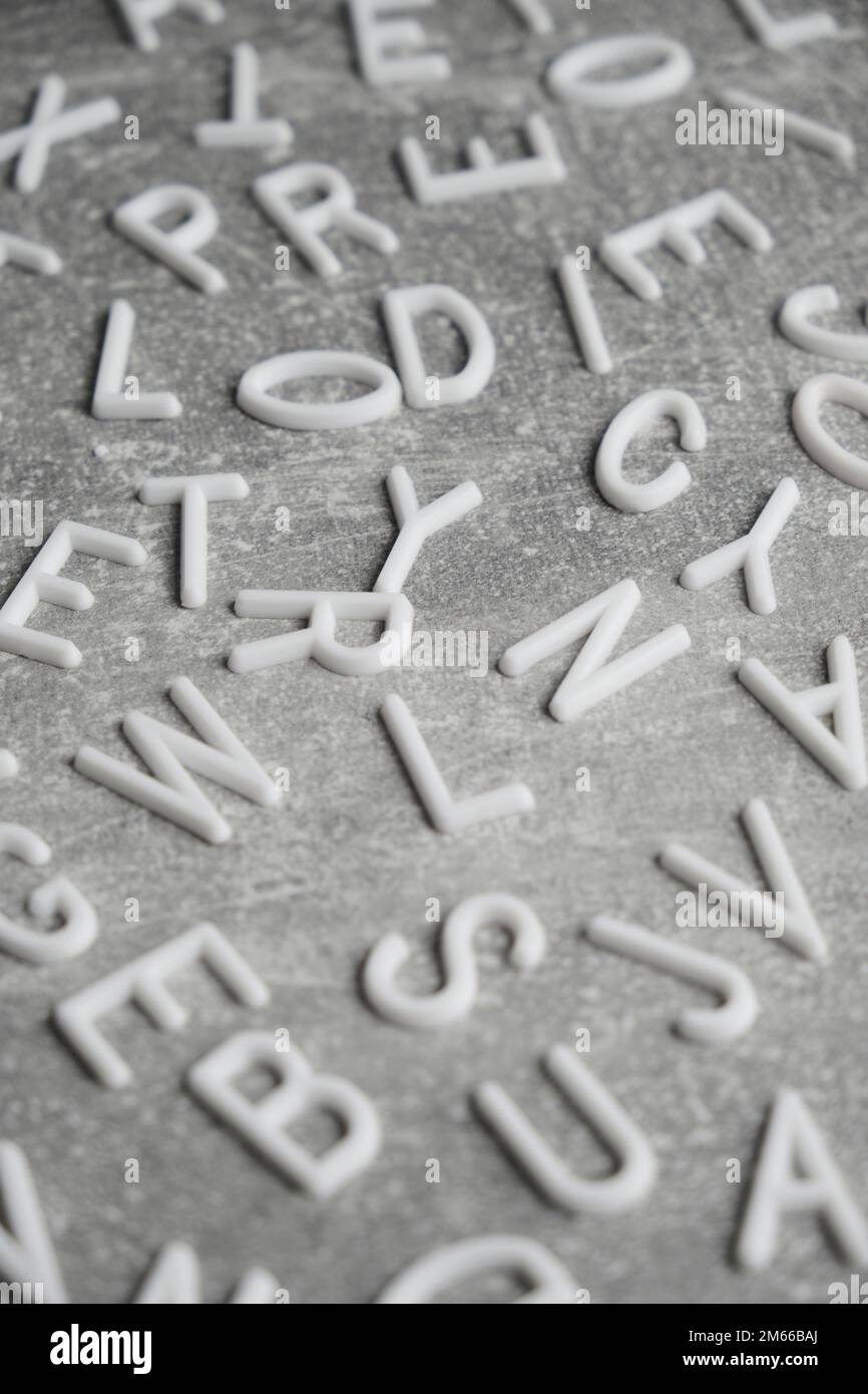 White letters English alphabet gray concrete background Stock Photo - Alamy