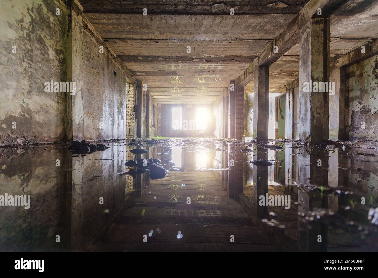 Inside of flooded dirty abandoned ruined industrial building with water ...