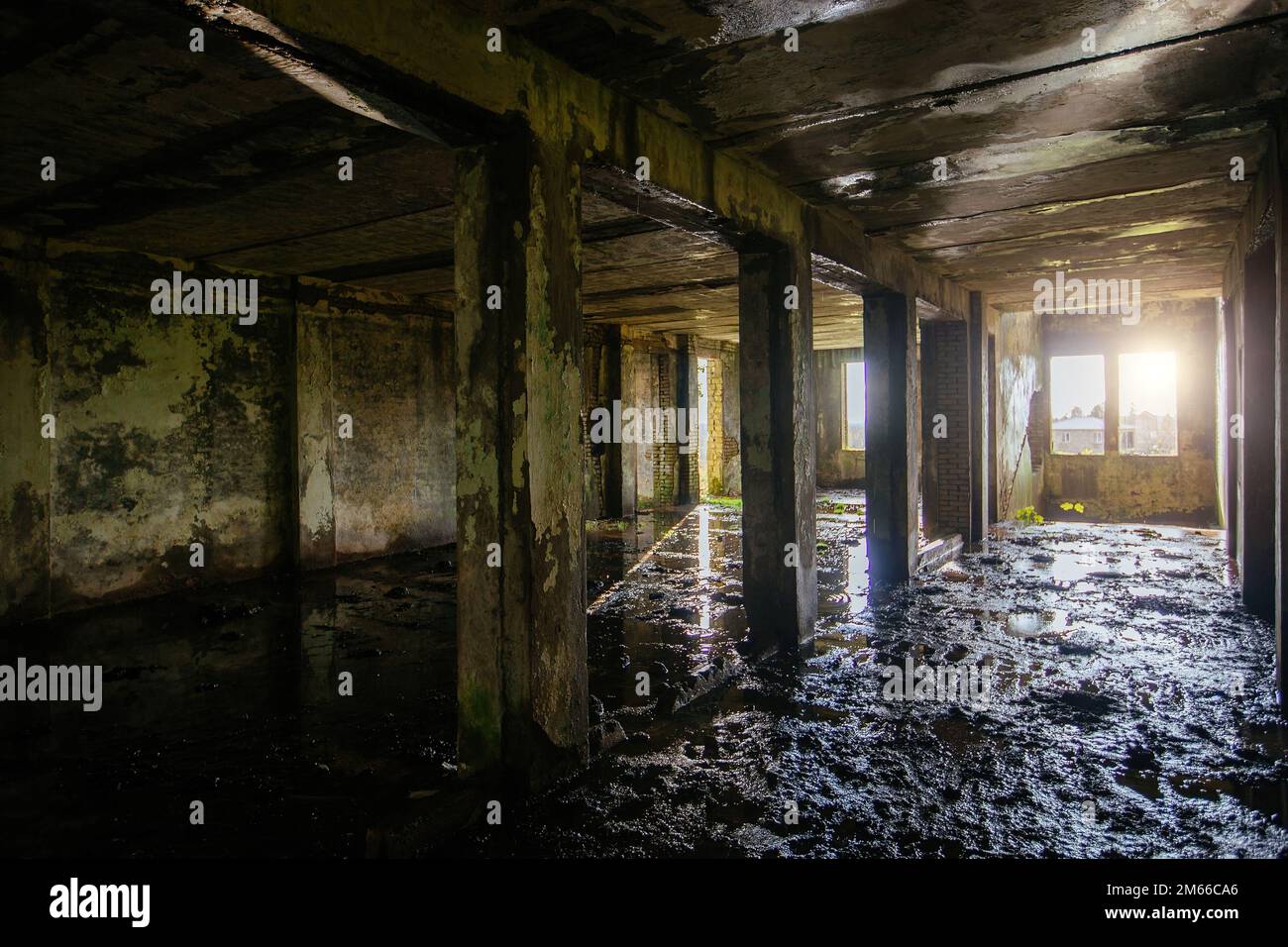 Inside of flooded dirty abandoned ruined industrial building with water ...
