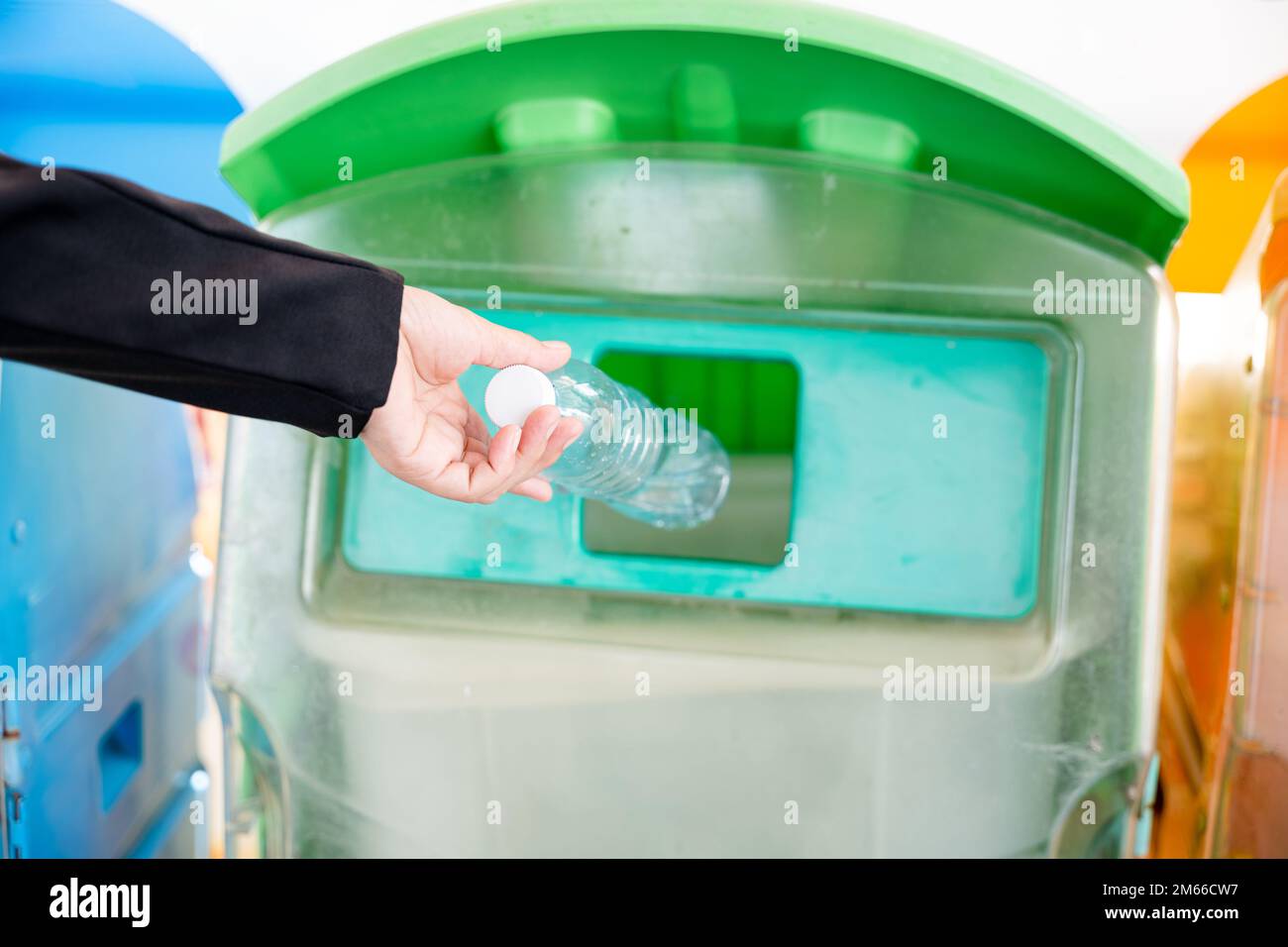 Business woman throwing empty plastic bottle water into recycle garbage ...