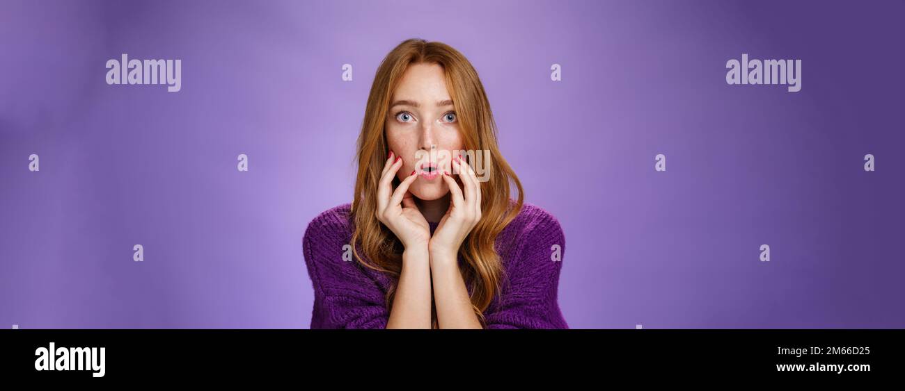 Shocked redhead female friend touching face and open mouth as looking ...