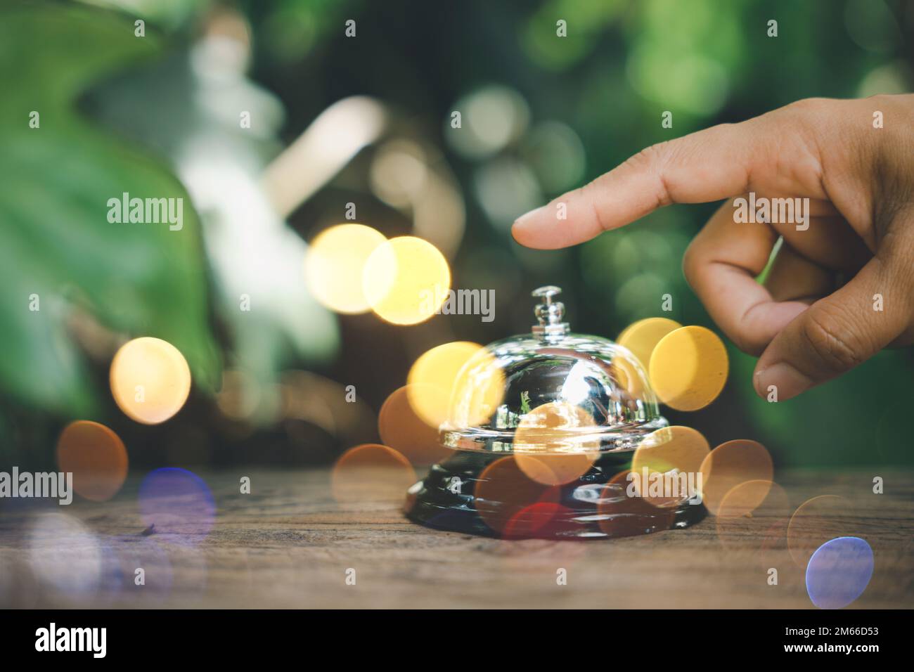 Customer hand ringing service bell at coffee cafe shop for calling the ...