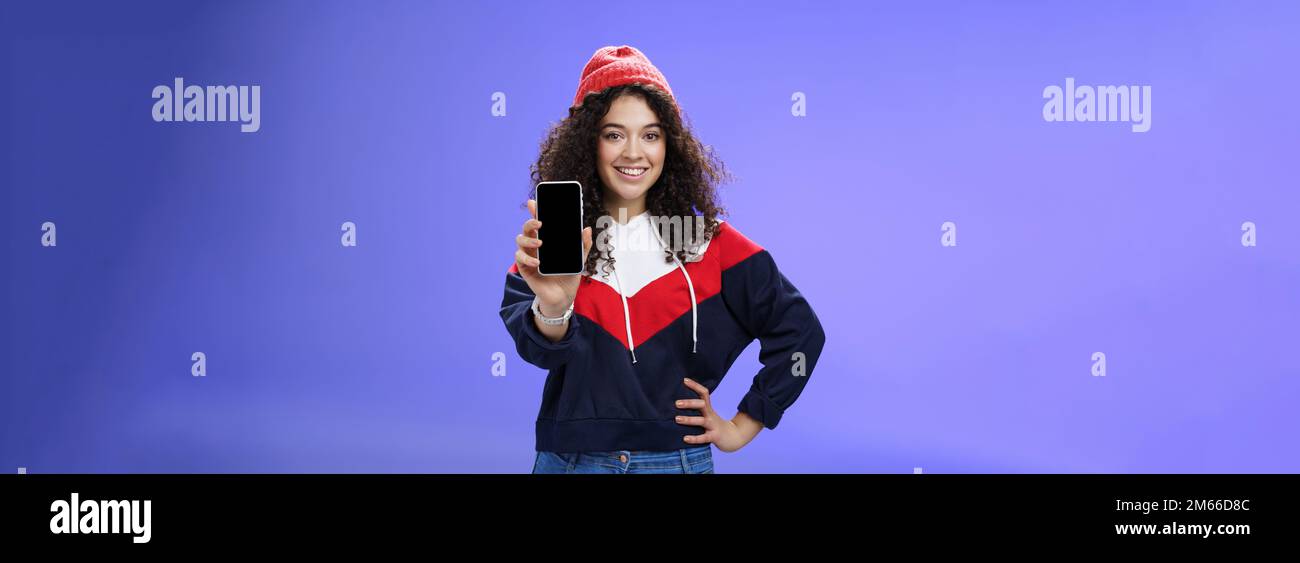 Girl showing her post as pulling smartphone screen towards camera ...