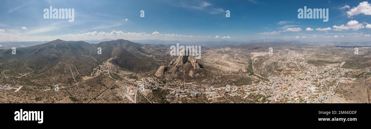 Panoramic view of Peña de Bernal, at the foot of the mountain the ...