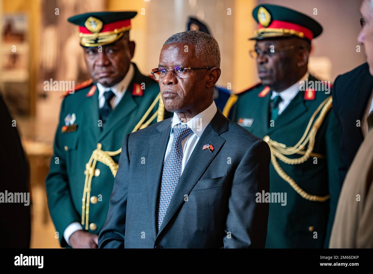 Francisco Pereira Furtado (center), minister of state, Angola, listens ...