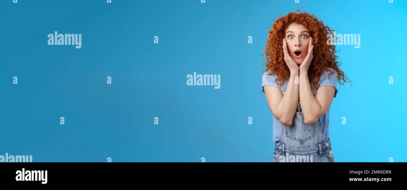 Amazed gasping shocked wondered redhead attractive curly girl popping ...