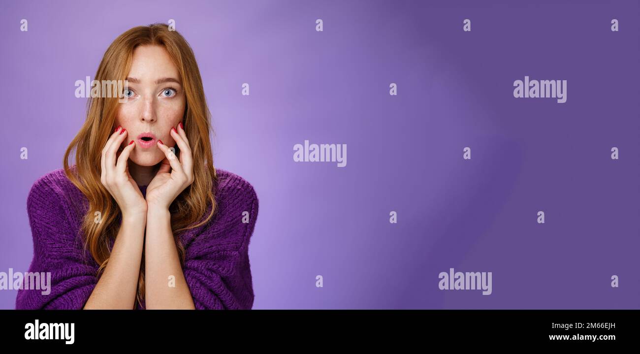Shocked redhead female friend touching face and open mouth as looking ...