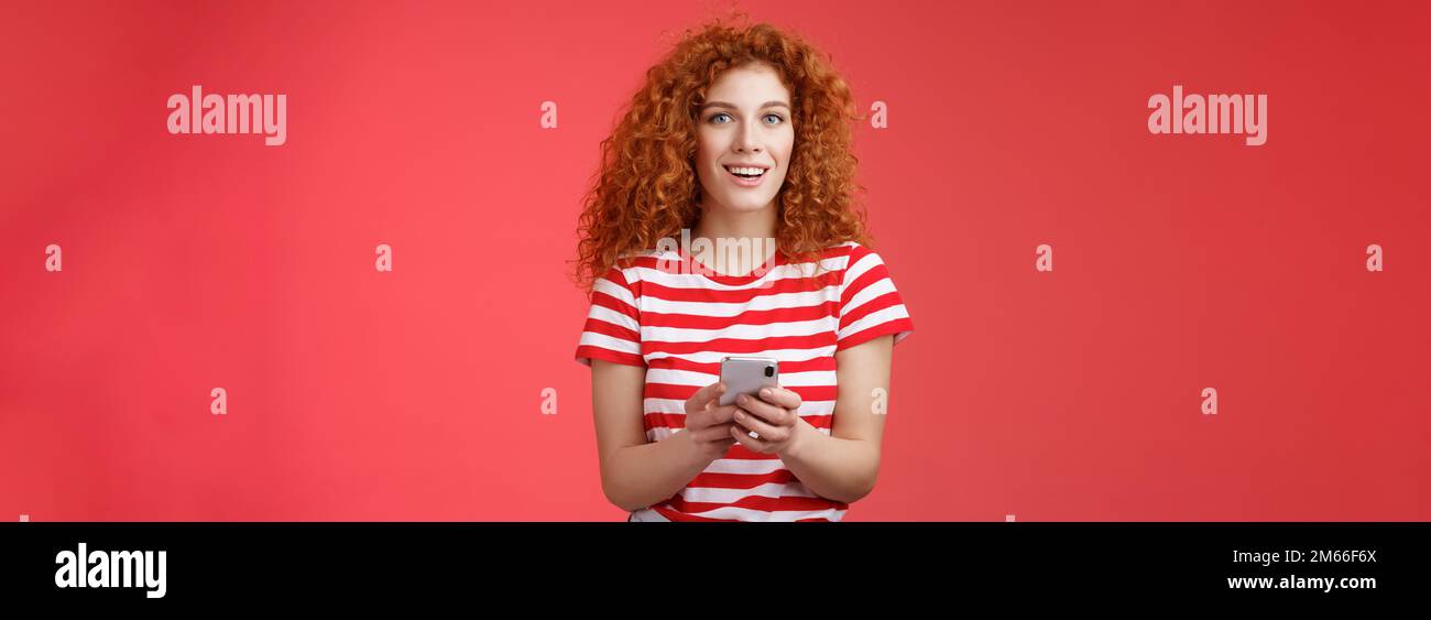 Fashionable carefree good-looking relaxed redhead girlfriend hold ...