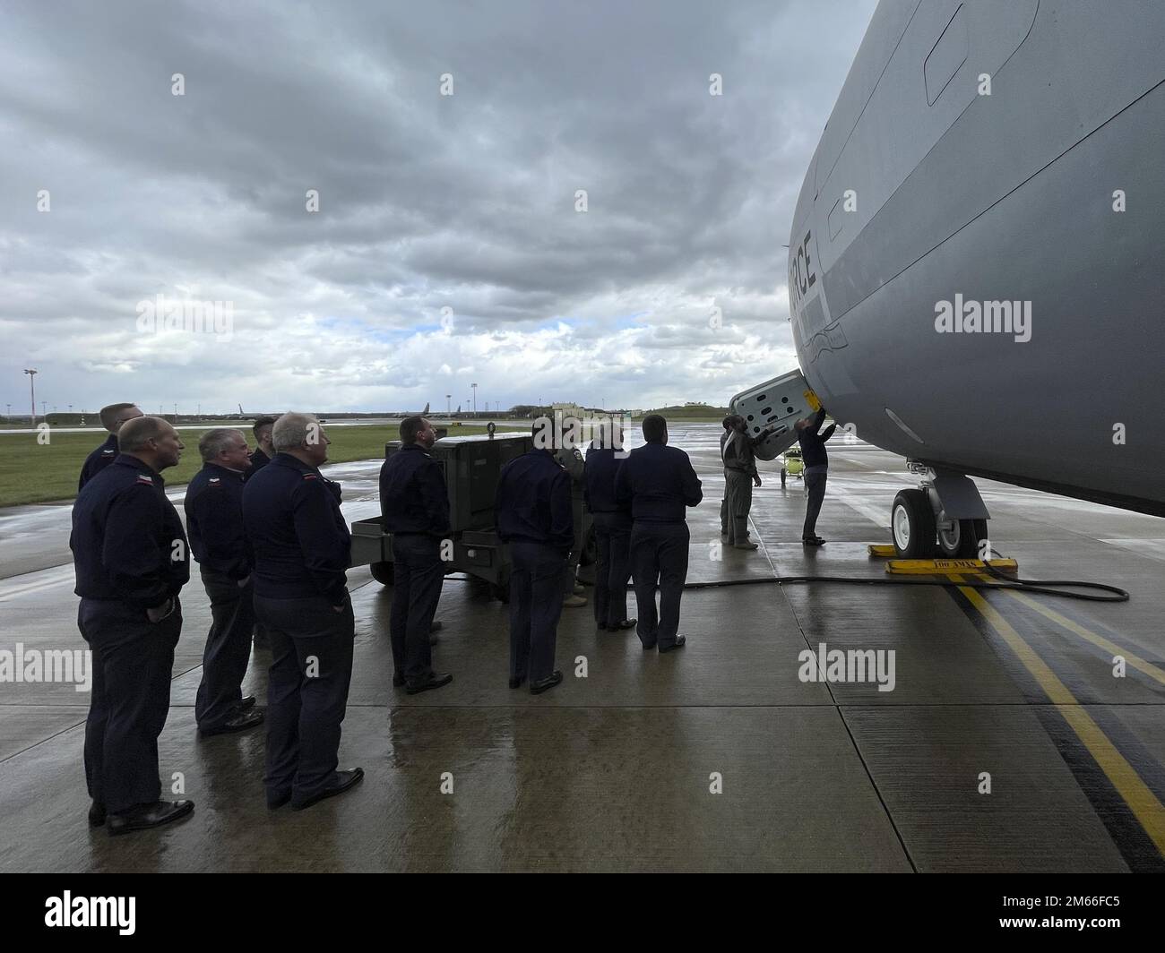Royal Air Force Police tour a KC-135 Stratotanker aircraft with U.S. Airmen assigned to the ...