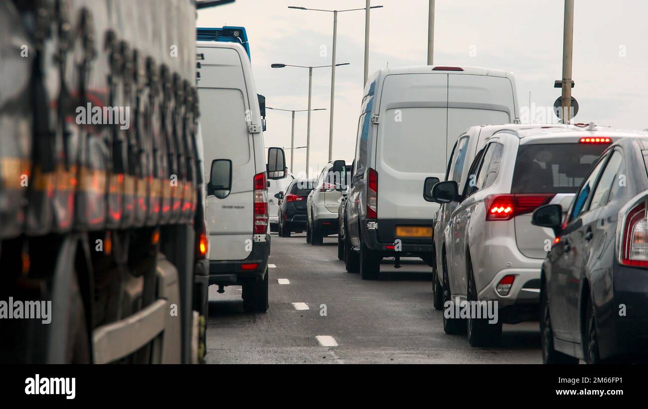 Heavy, slow moving traffic in a jam at rush hour on a busy main road ...