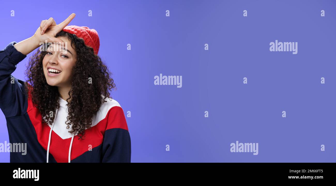 Girl triumphing and mocking friend as winning showing loser gesture on ...