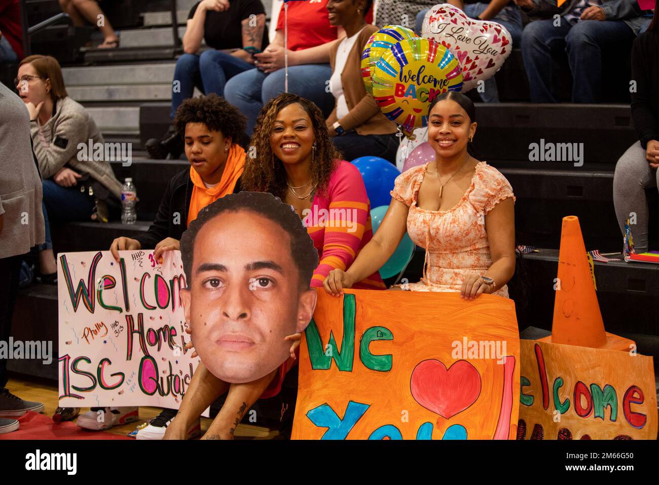 Mia Qutaishat, center, with children Latalyia and David Jr. hold signs ...