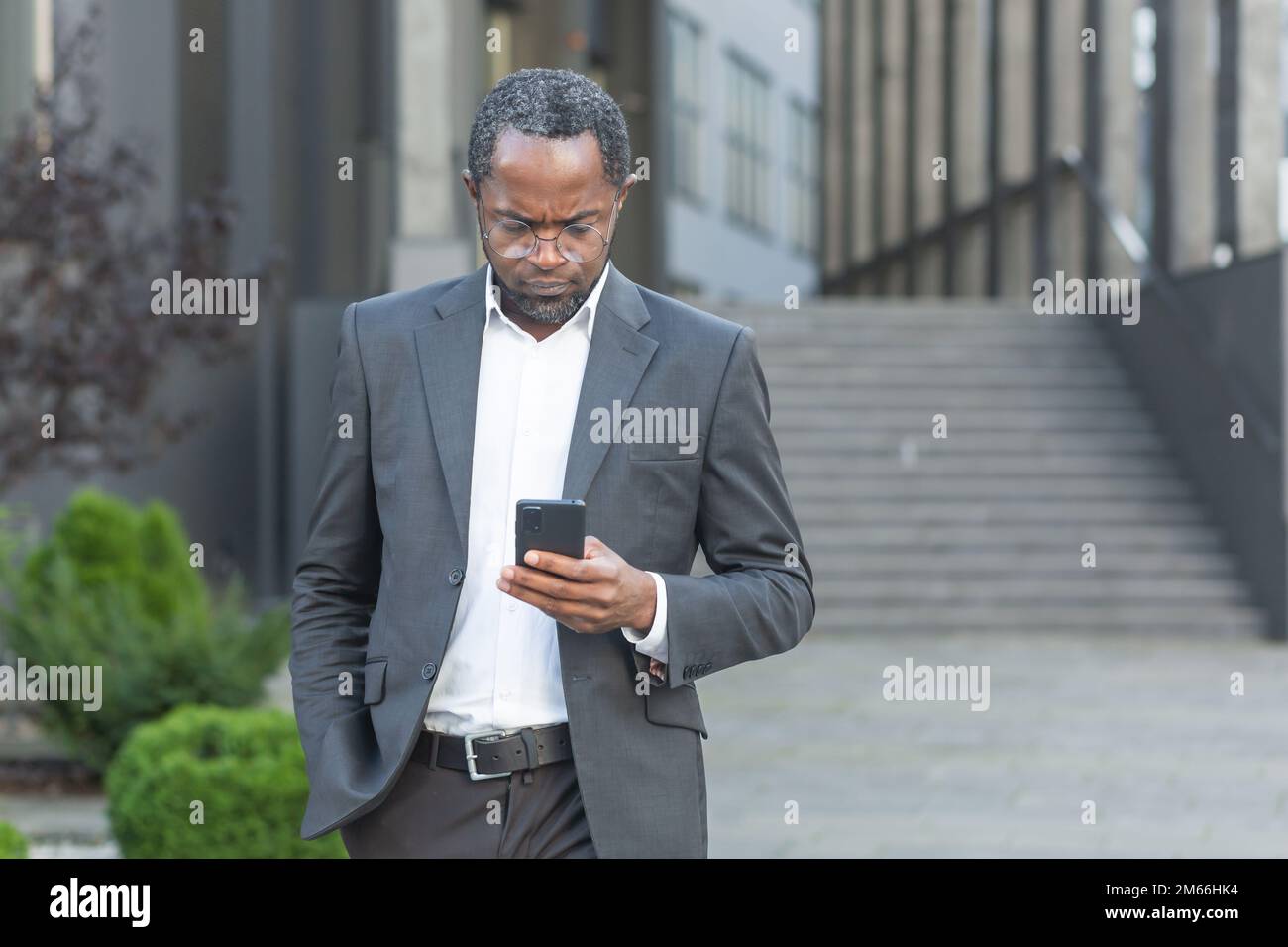 Serious and successful African American boss businessman outside office ...